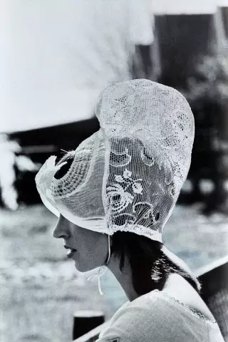 Talitha Getty em uma vila de pescadores holandesa usando um grande boné bordado branco 1971