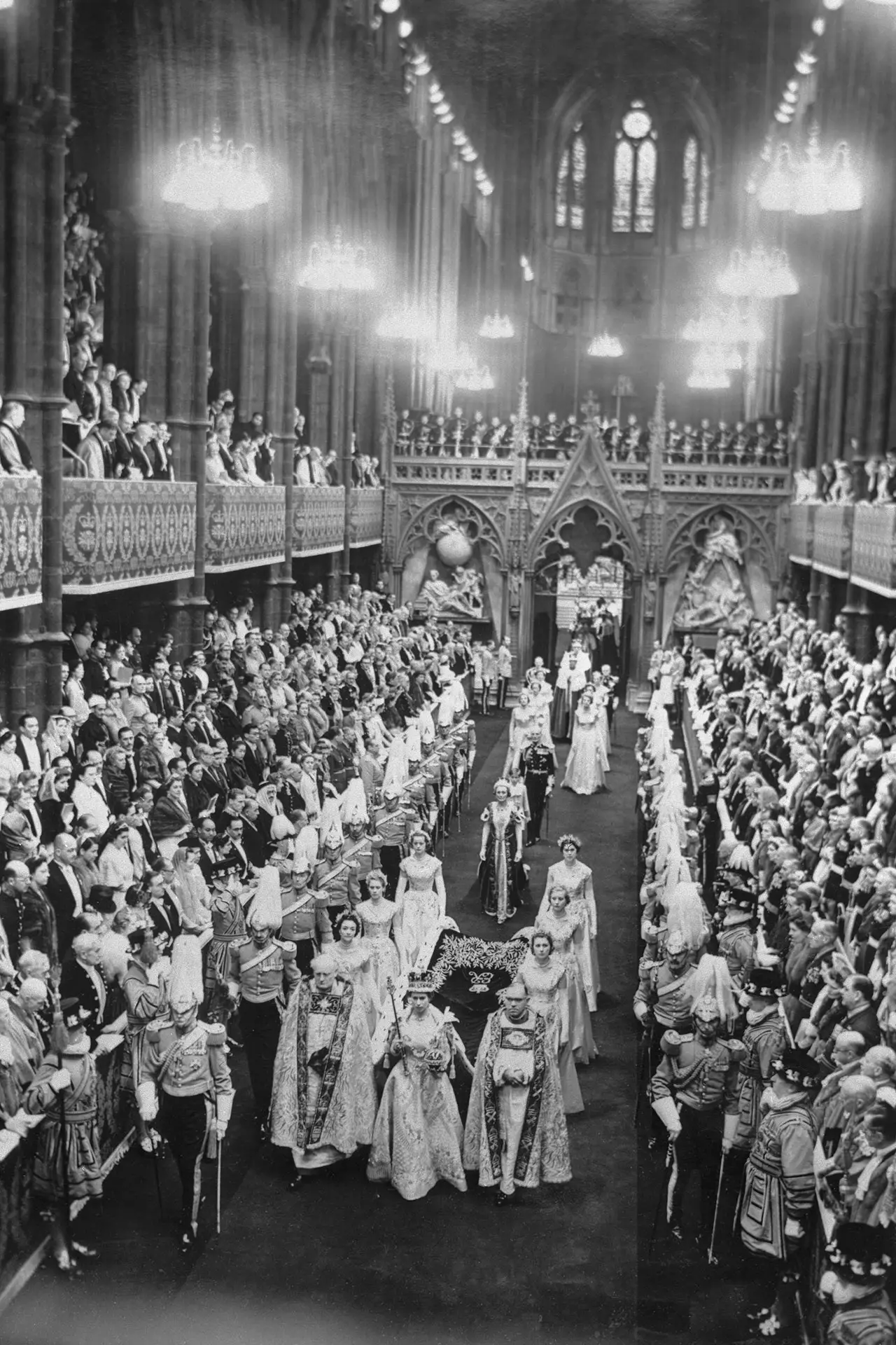 De processie van de koningin met de kroningsmeisjes die haar trein dragen